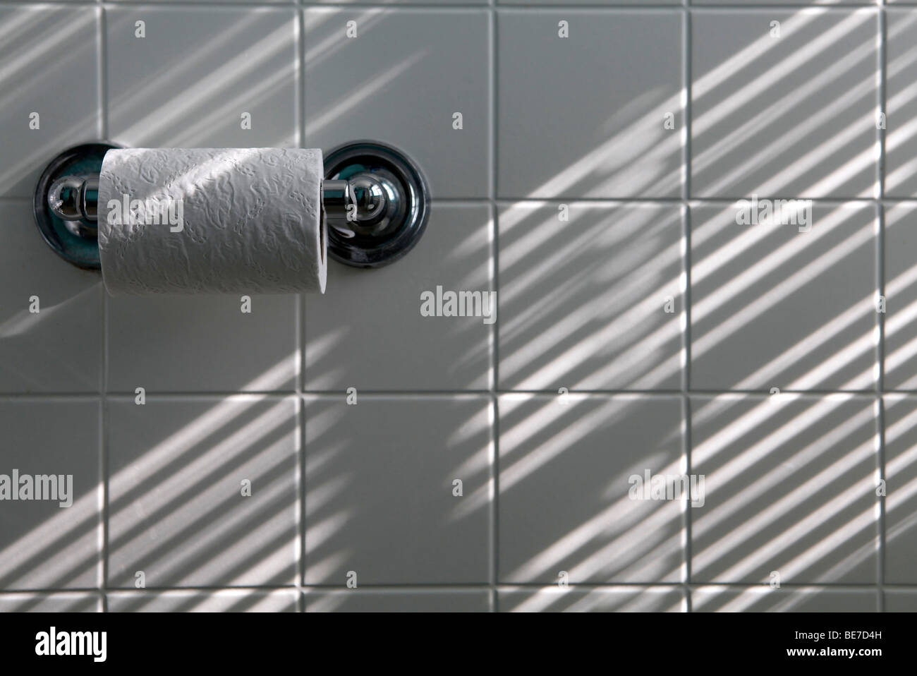 toilet paper roll white tile bathroom Stock Photo - Alamy