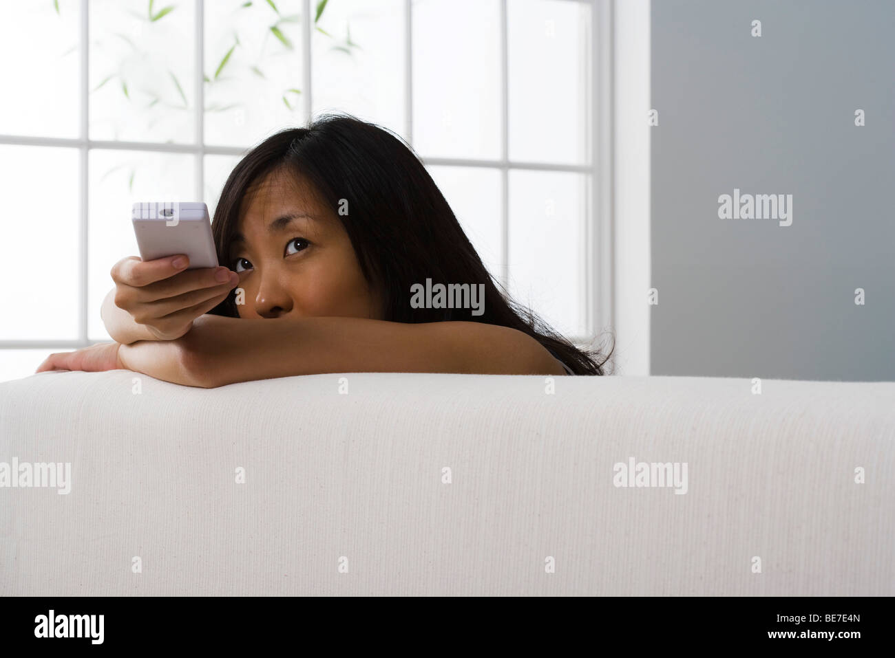 Woman using remote control Stock Photo - Alamy Woman using remote control Stock Photo - Alamy