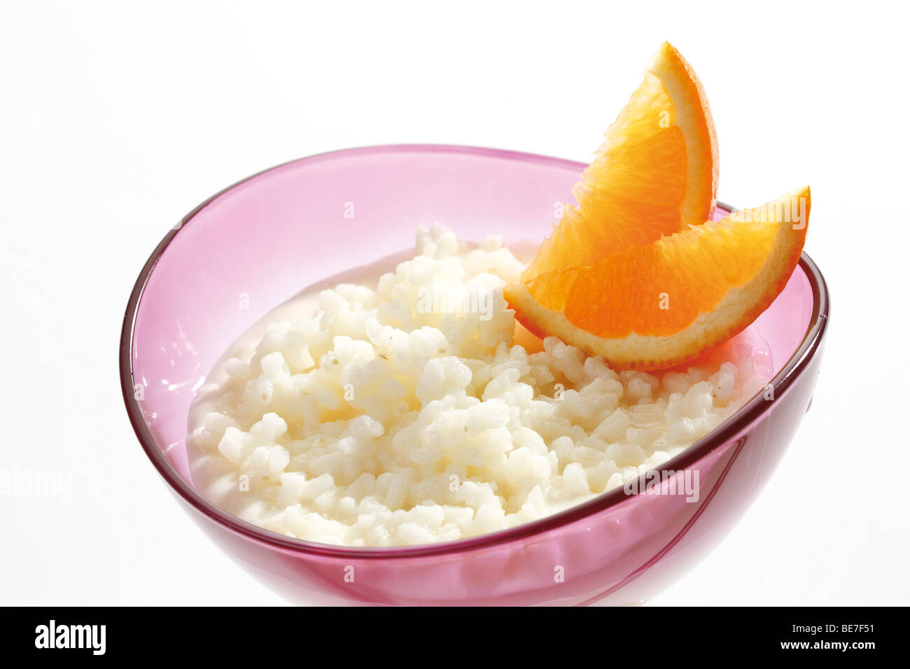 Rice pudding and orange slices in a glass bowl Stock Photo - Alamy