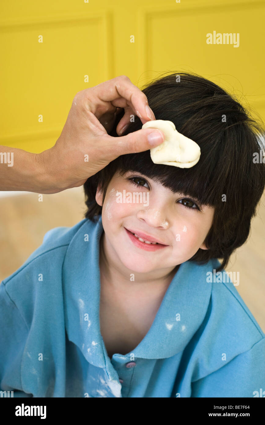 Parent holding dough against little boy's head, cropped Stock Photo - Alamy