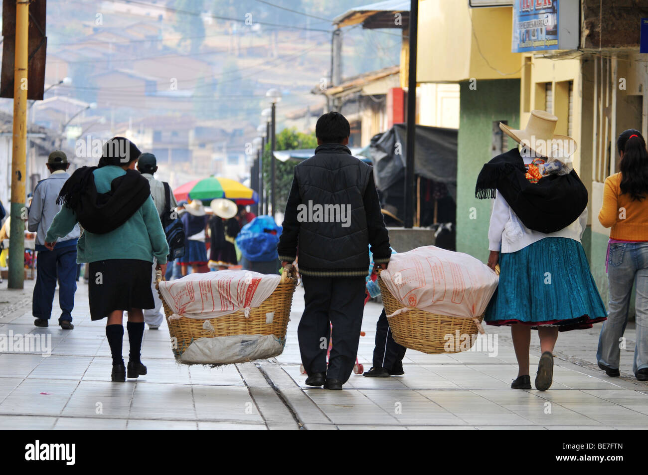 CAJABAMBA PERU - SEPTEMBER 9: Street vendor carrying baskets of bread ...