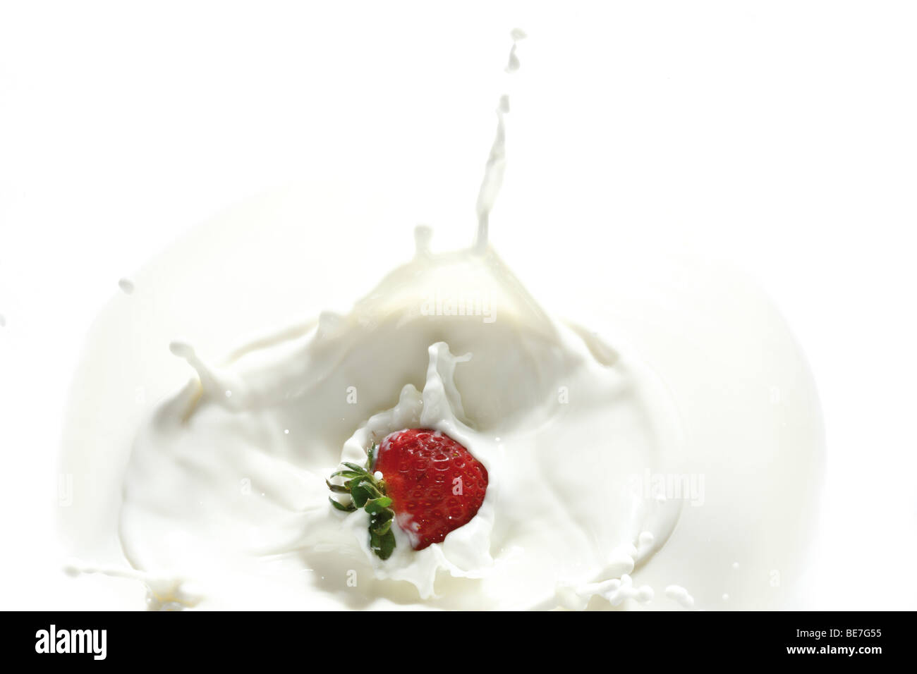 Strawberry falling into milk Stock Photo - Alamy