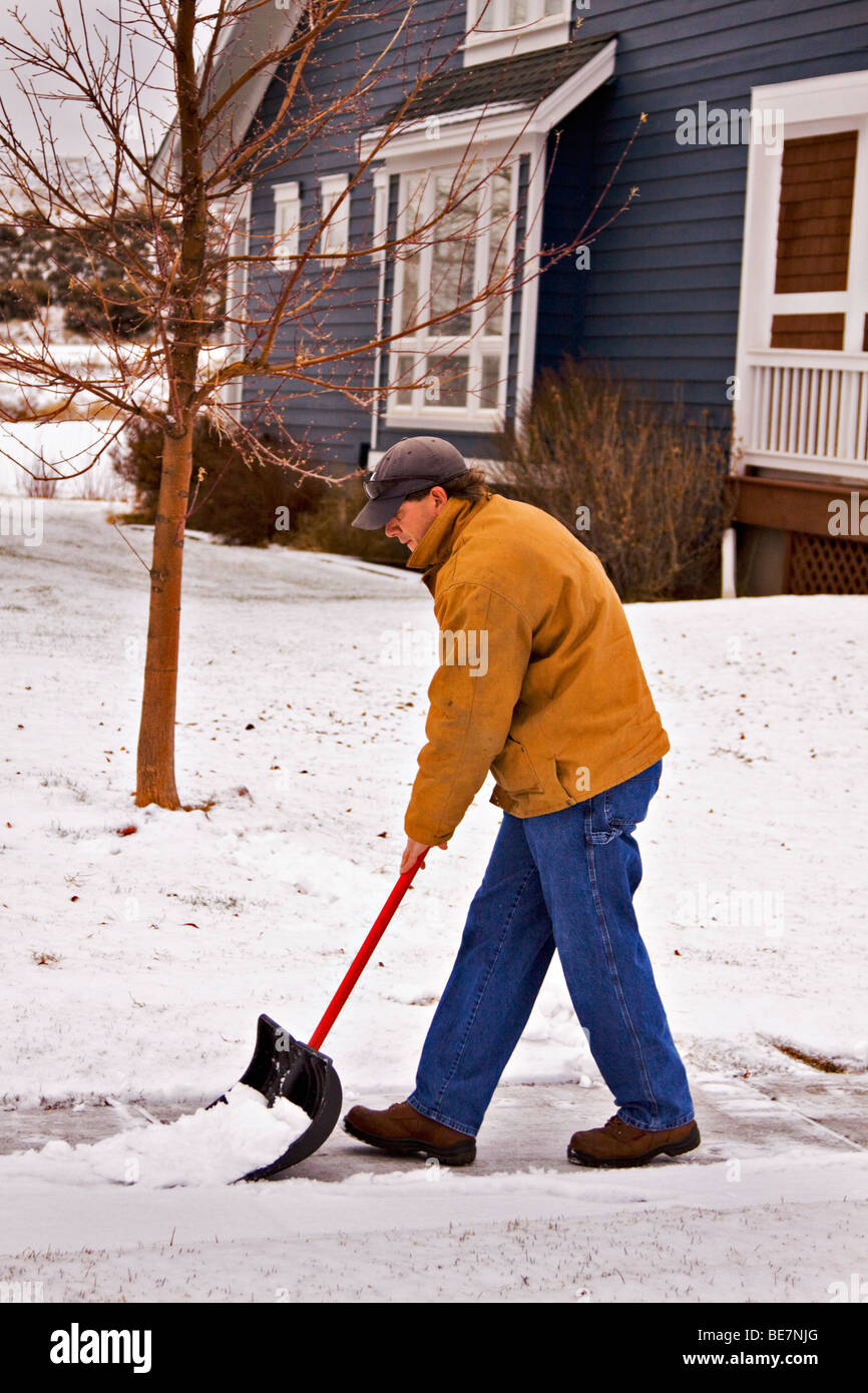 Man shoveling snow Stock Photo - Alamy