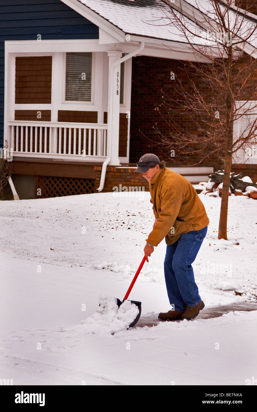 Man shoveling snow Stock Photo - Alamy