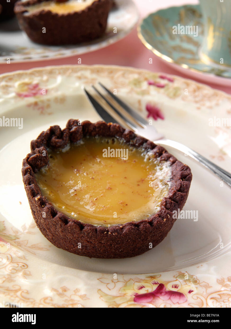 Chocolate custard tart on an antique plate in a table setting Stock ...
