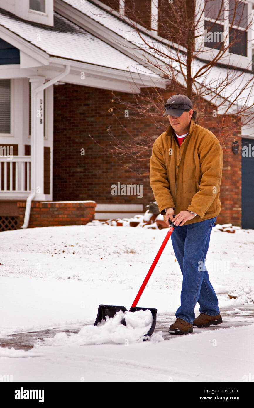 Man shoveling snow Stock Photo - Alamy