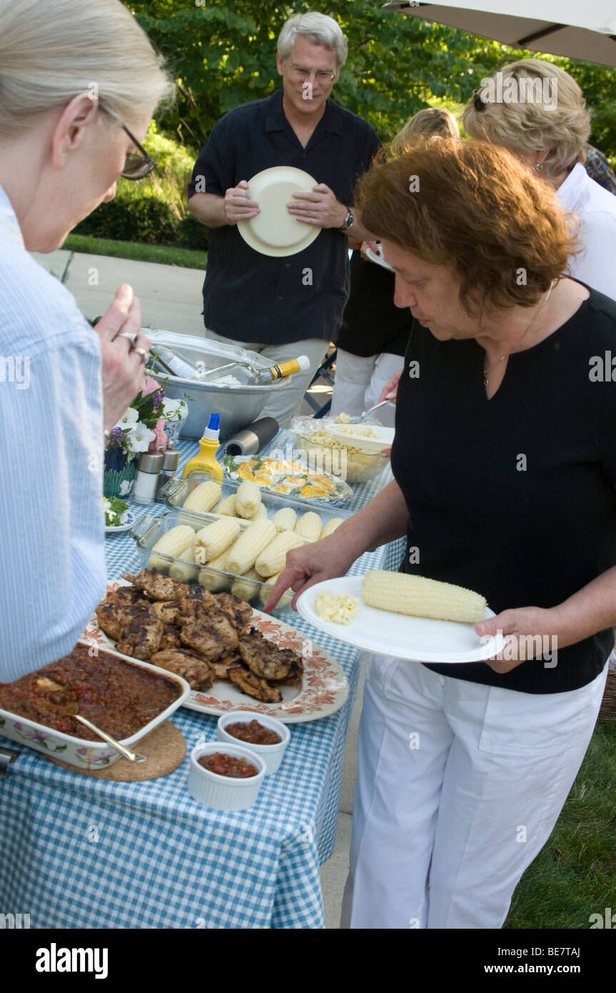 Neighborhood buffet picnic table, chicken corn beans wine Stock Photo ...