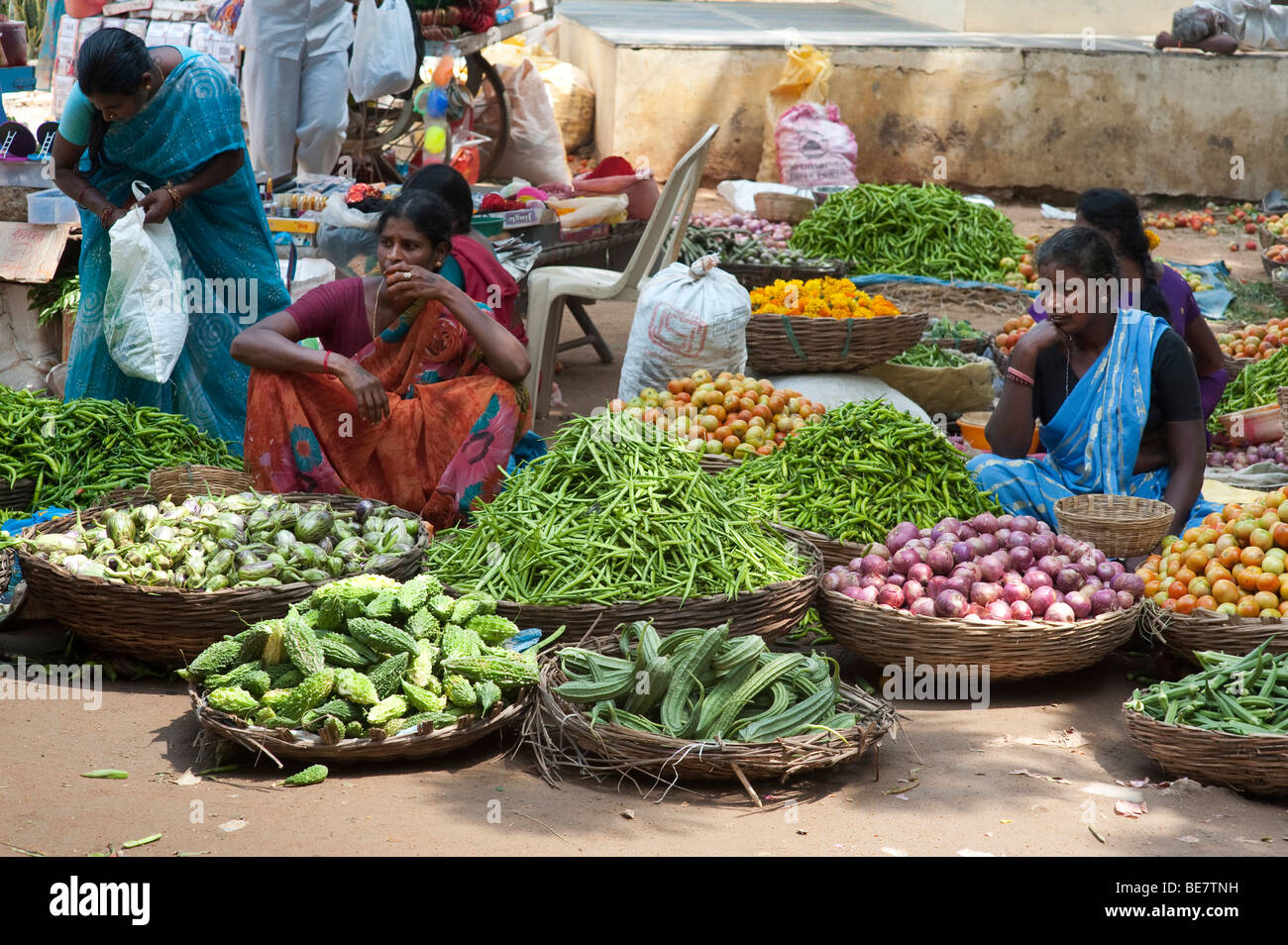 Indian street market in Puttaparthi with baskets of vegetables. Andhra ...