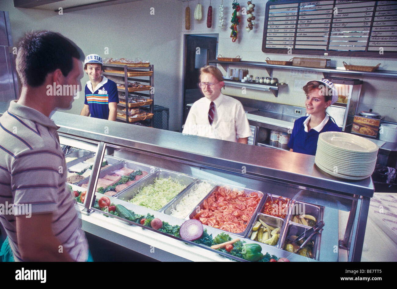 College student selects food at campus cafeteria food service Stock ...