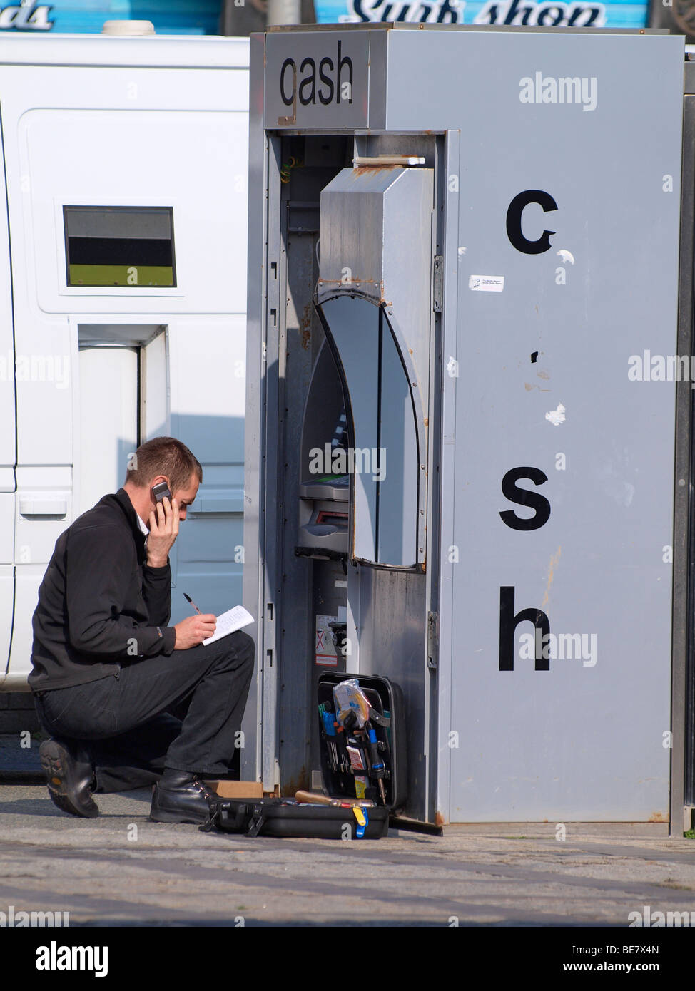 Engineer fixing a cash machine Stock Photo - Alamy