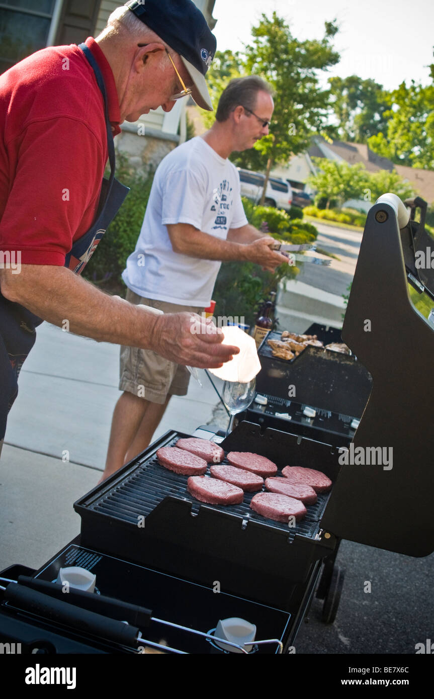 Chefs prepare burgers on grill hi-res stock photography and images - Alamy