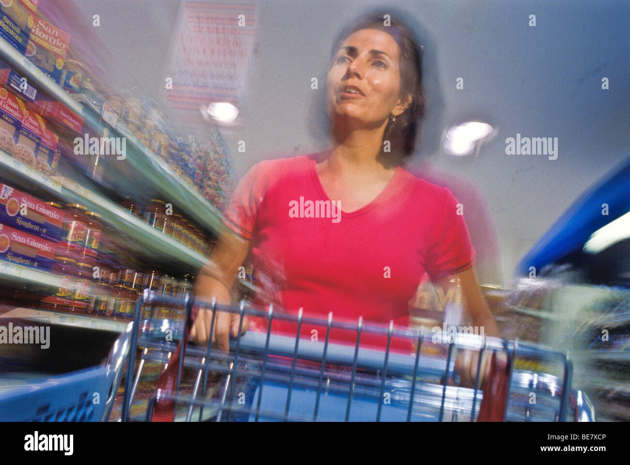 One female woman rushing through weekly family shopping chores. motion ...