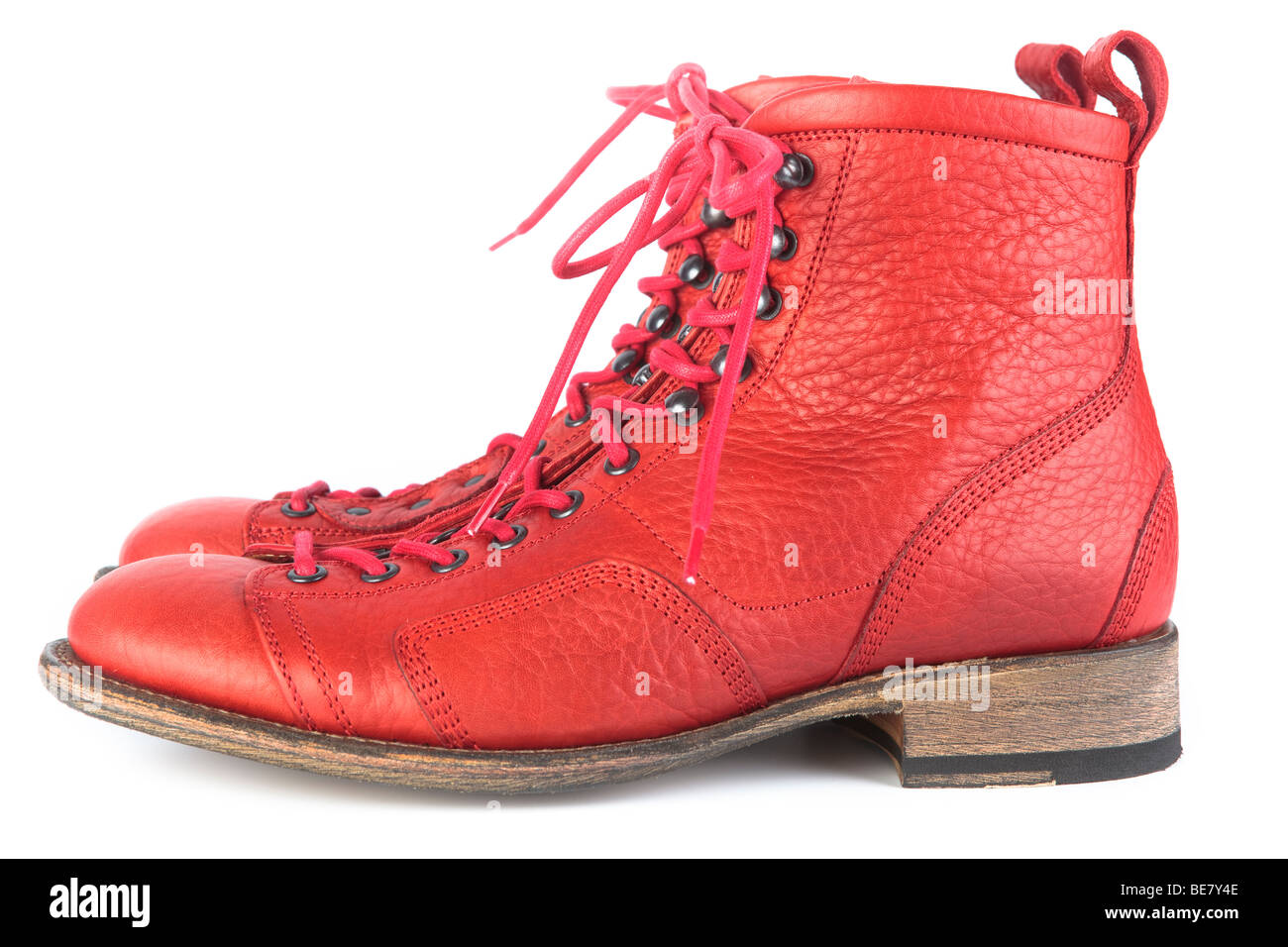 Red shoes with laces on a white background Stock Photo - Alamy
