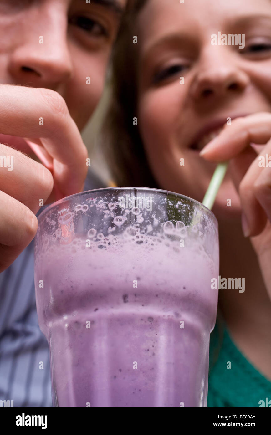 Trendy young couple sharing a delicious milkshake in a cool cafe Stock ...