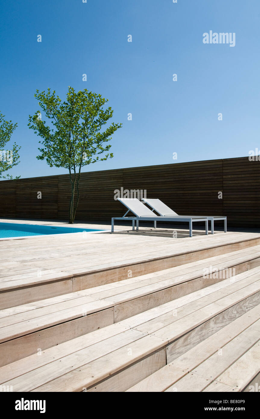 Sunloungers at the terrace next to the pool under blue sky, Hotel Riva ...