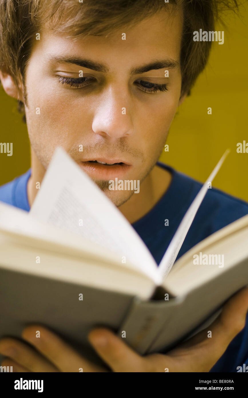 Young man reading book, close-up Stock Photo - Alamy