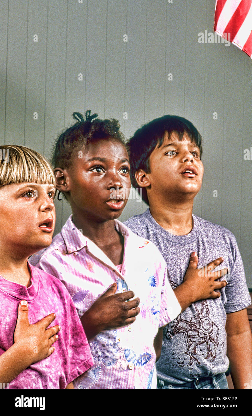 Young children pledging allegiance for American flag in school Stock ...