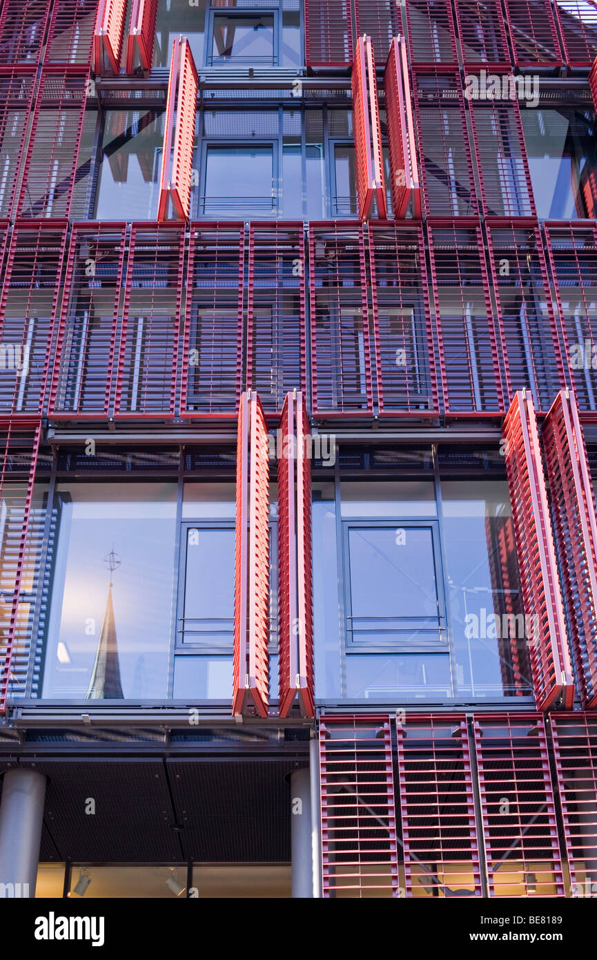 House with windows and red blinds, Reflection of a church tower in the ...