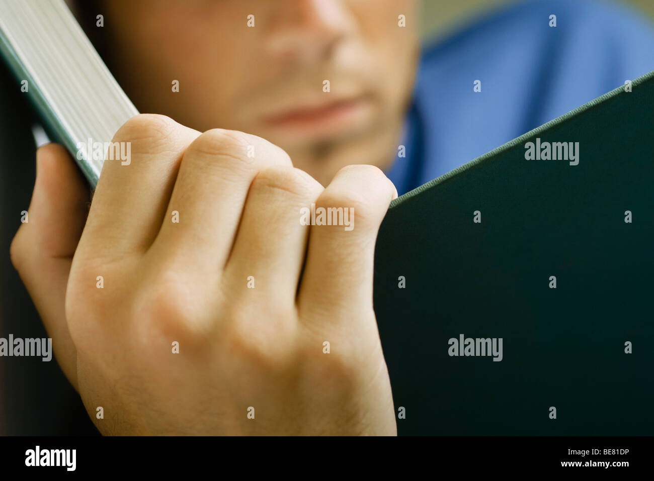 Man reading book, cropped Stock Photo - Alamy
