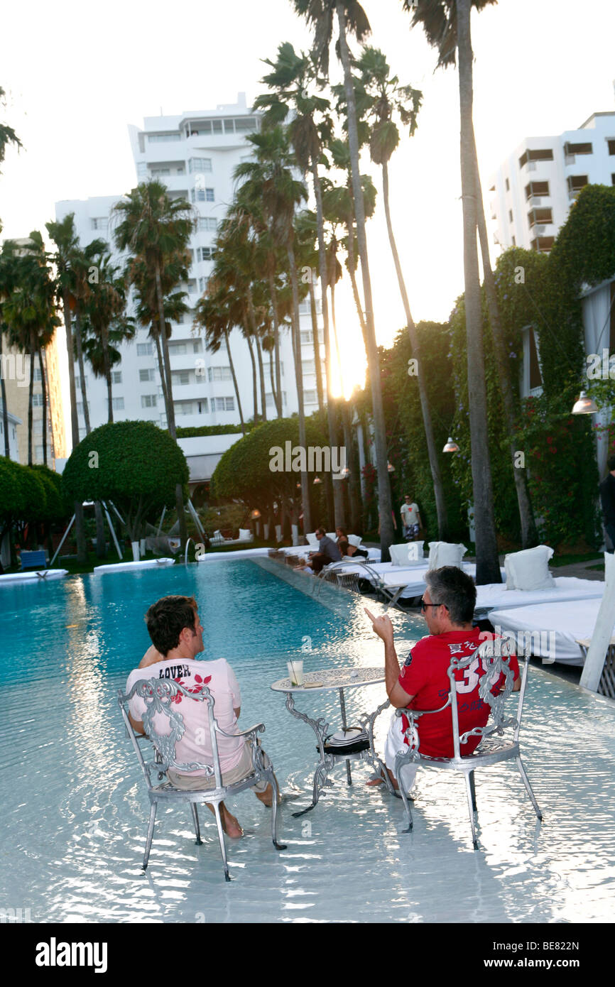 Two Men Relaxing At The Delano Hotel Pool At Sunset South Beach Miami