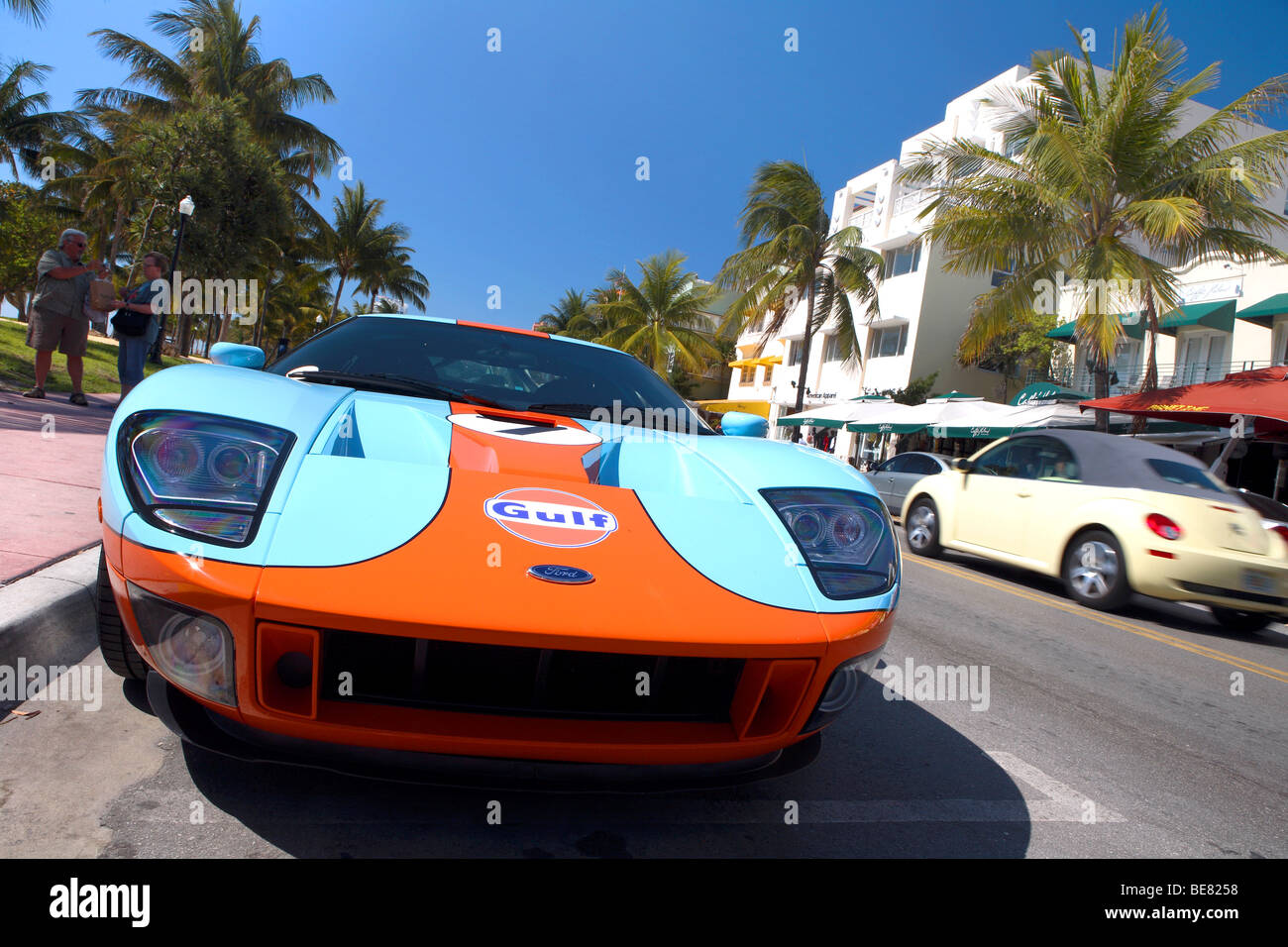 Sports car parking on Ocean Drive under blue sky, South Beach, Miami ...
