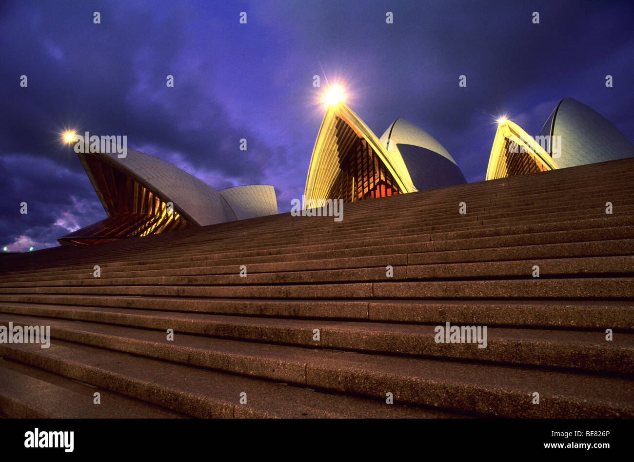 View at stairs in front of the illuminated Opera House in the evening ...
