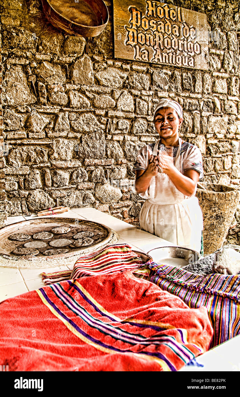Close up of woman making bread tortillas near ancient oven of the ...