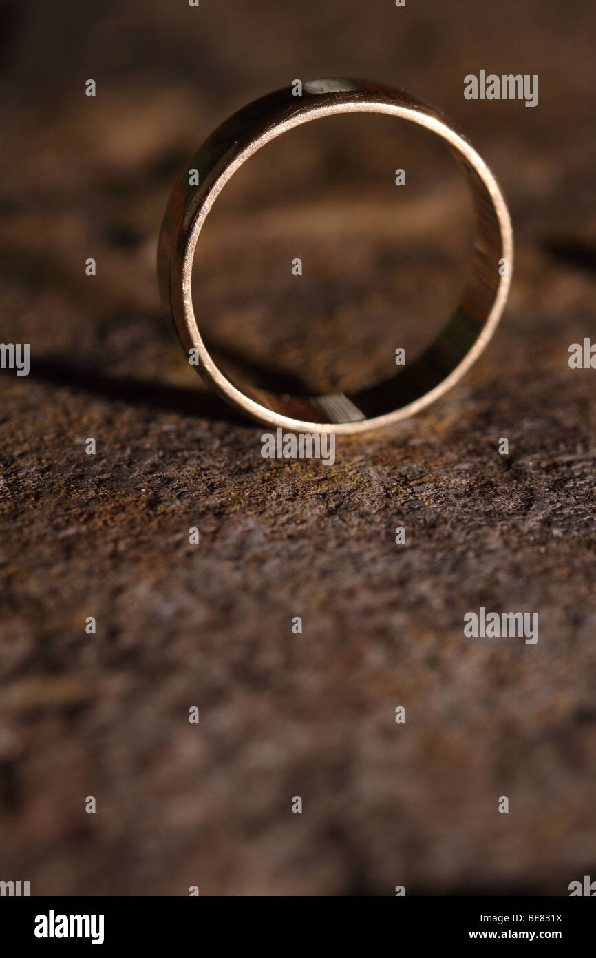 Golden gold wedding ring on stone Stock Photo - Alamy
