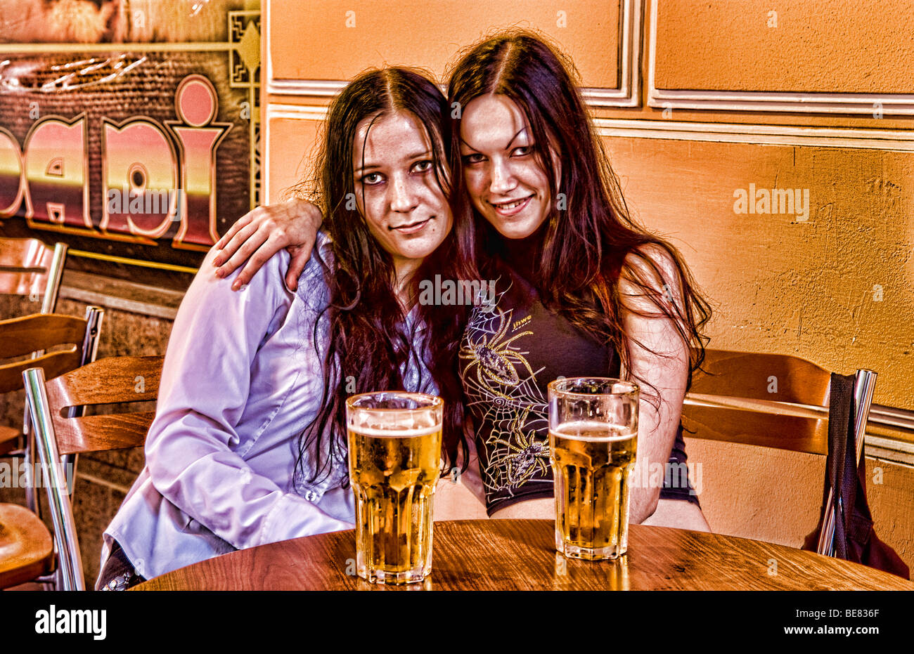 The Gothic life of girl teenagers having beer at restaurant in black ...