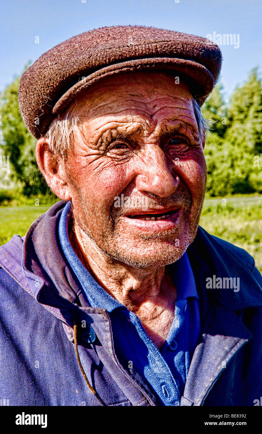 Portrait of poor farming man with his cow in rural farms between Kiev ...