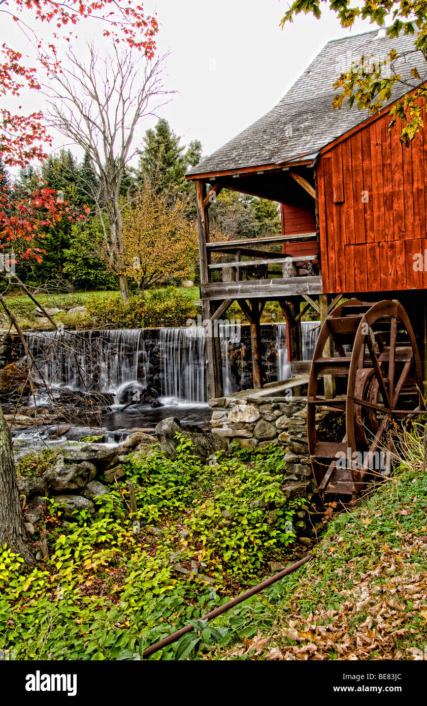 Historical Old grist Mill with waterfall on river in village of Weston ...