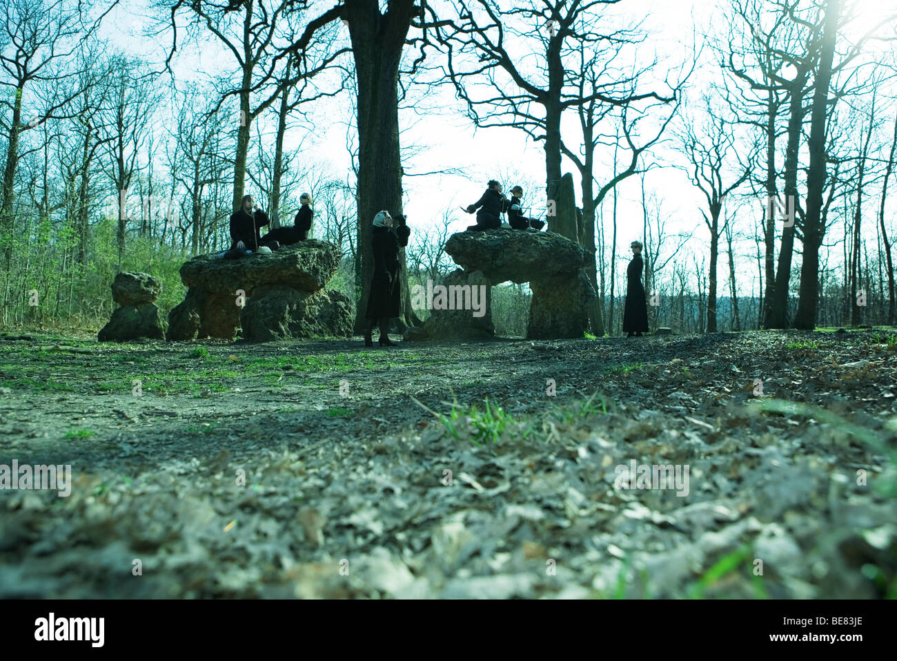 People dressed in black in woods, using laptop computers and landline ...