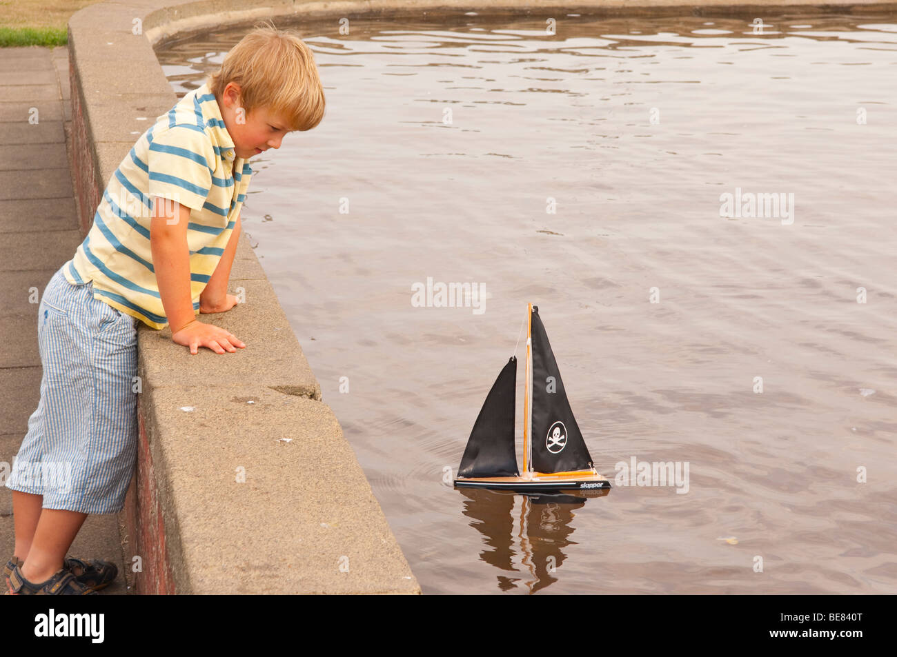 Boys with toy boat hi-res stock photography and images - Alamy