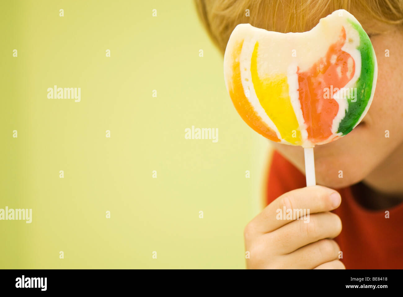 Child holding up lollipop Stock Photo - Alamy