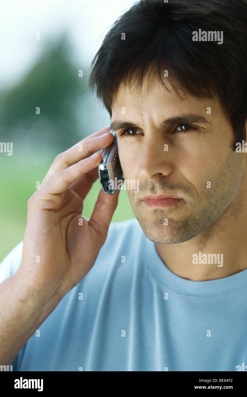 Man using cell phone with look of determination Stock Photo - Alamy