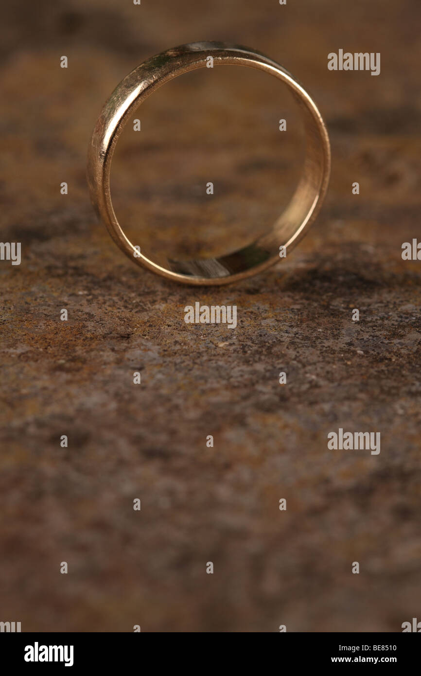 Golden gold wedding ring on stone Stock Photo - Alamy