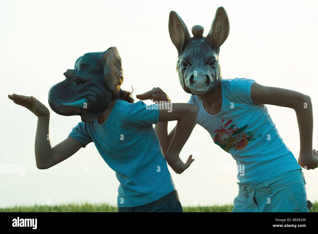 Two females wearing animal masks outdoors, gesturing with arms Stock ...