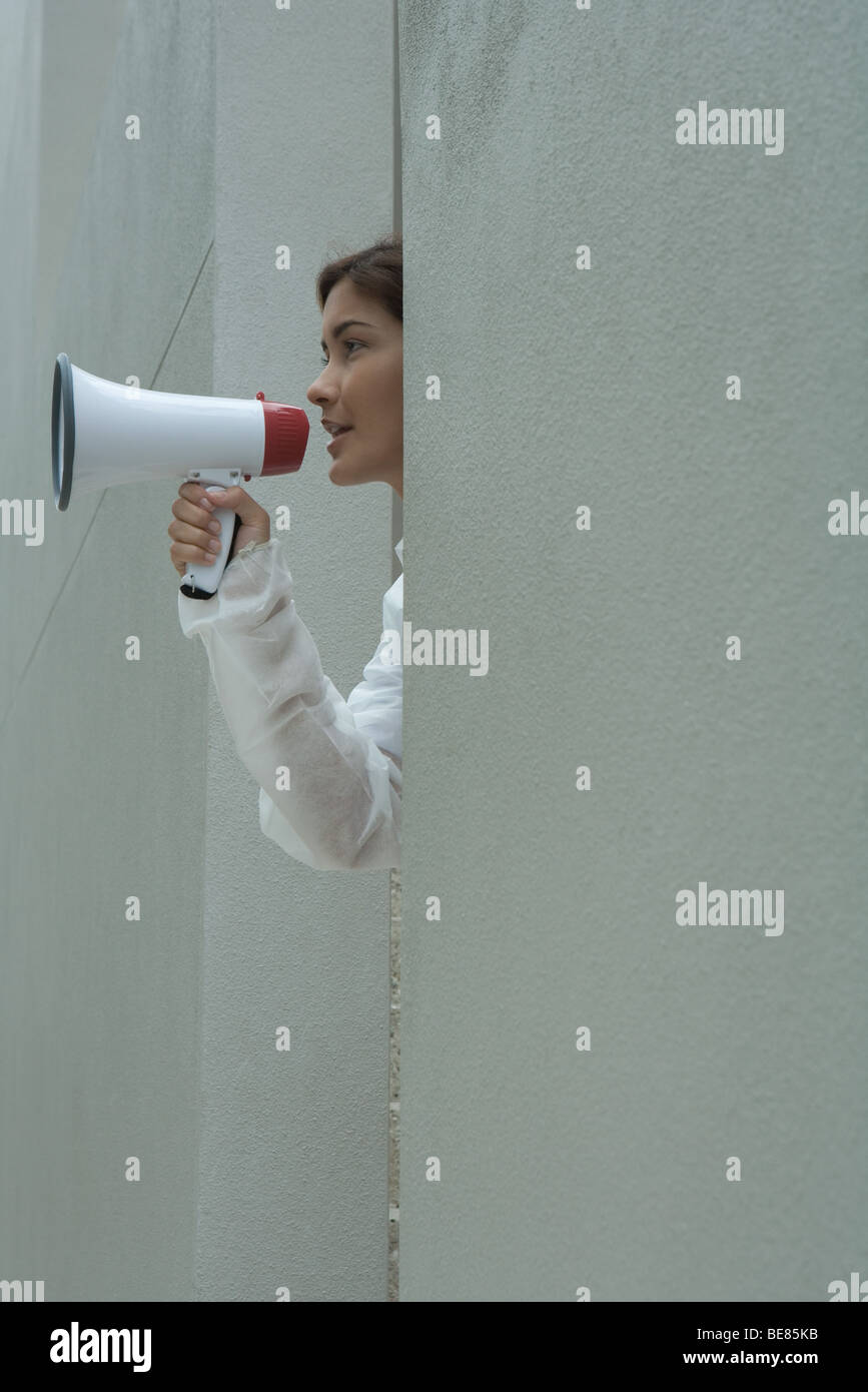 Woman speaking into megaphone, side view Stock Photo - Alamy