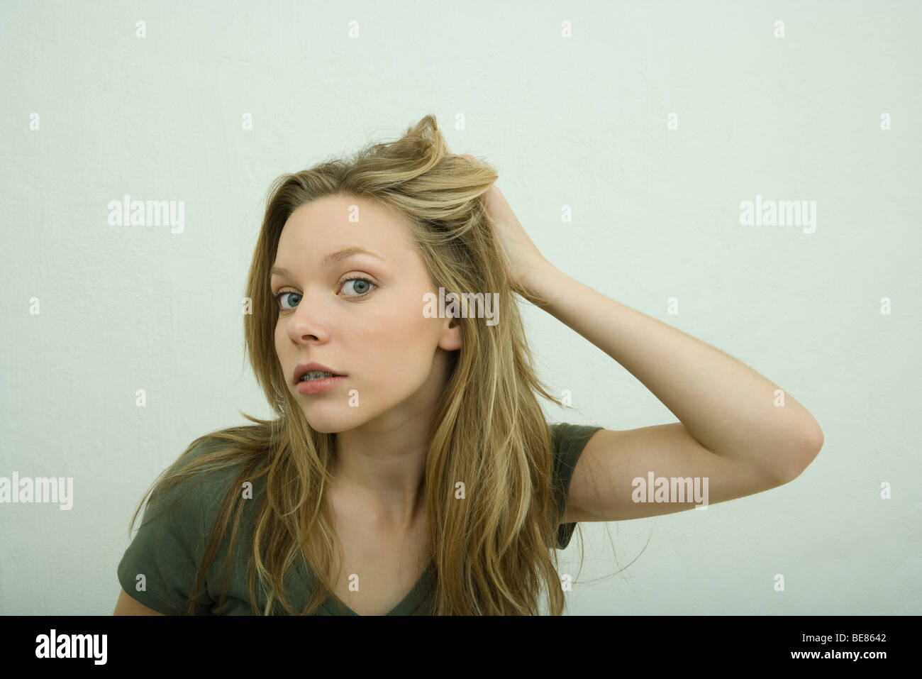 Teen girl with hand in hair Stock Photo - Alamy