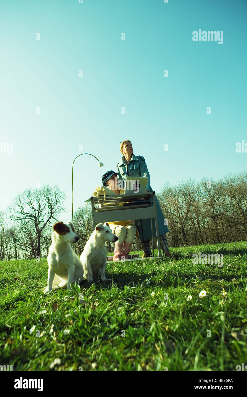 Outdoor office scene, office workers pausing work, looking away, dogs ...