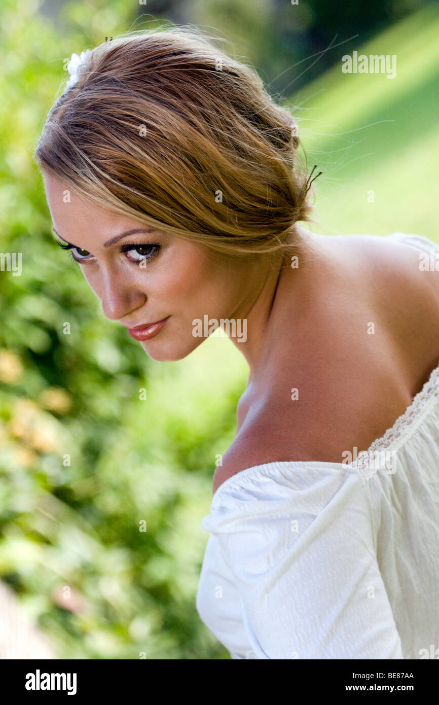 Young woman looking over the shoulder Stock Photo - Alamy