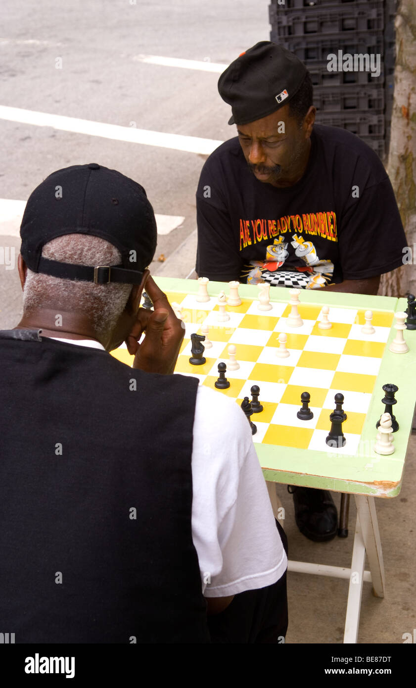 Black men playing chess downtown of unusual hippie village of Asheville ...