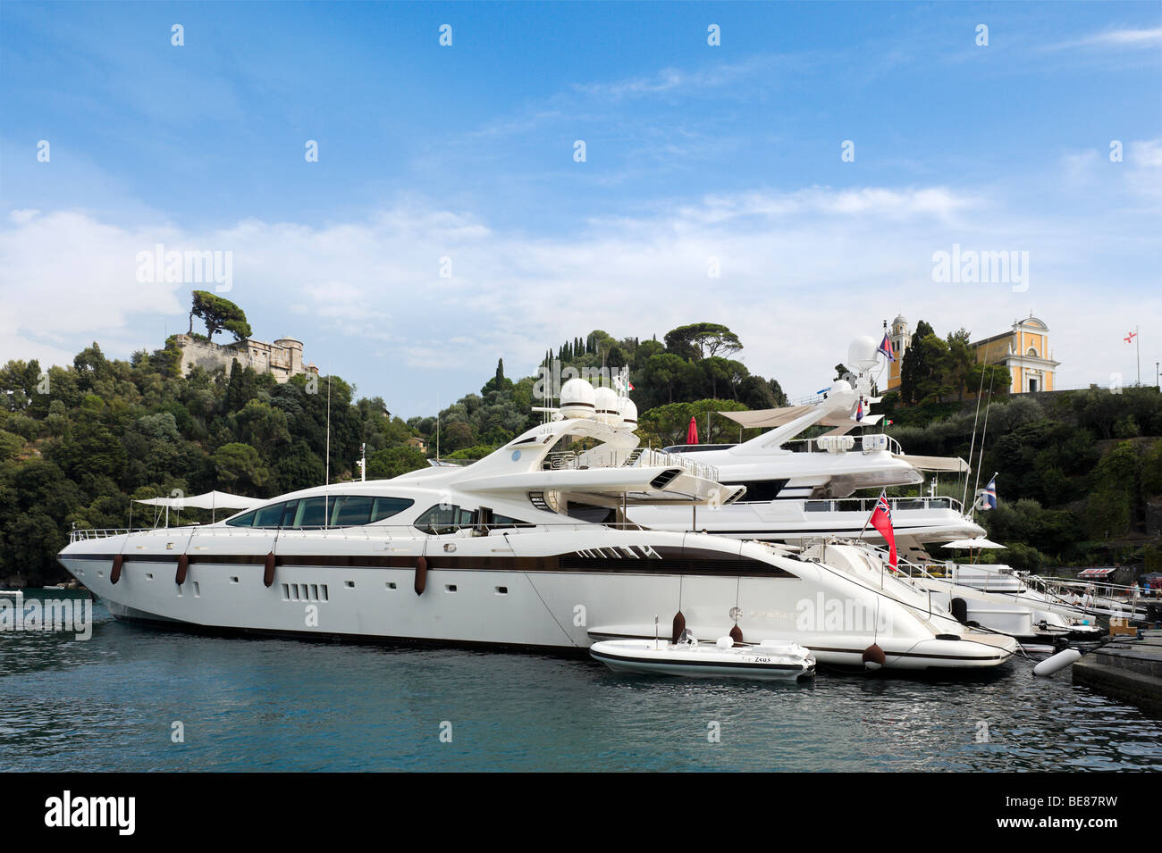 Luxury yachts in the harbour at Portofino with Castello Brown and ...