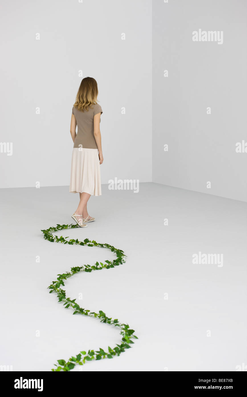 Woman walking, vine trailing behind her, rear view Stock Photo - Alamy