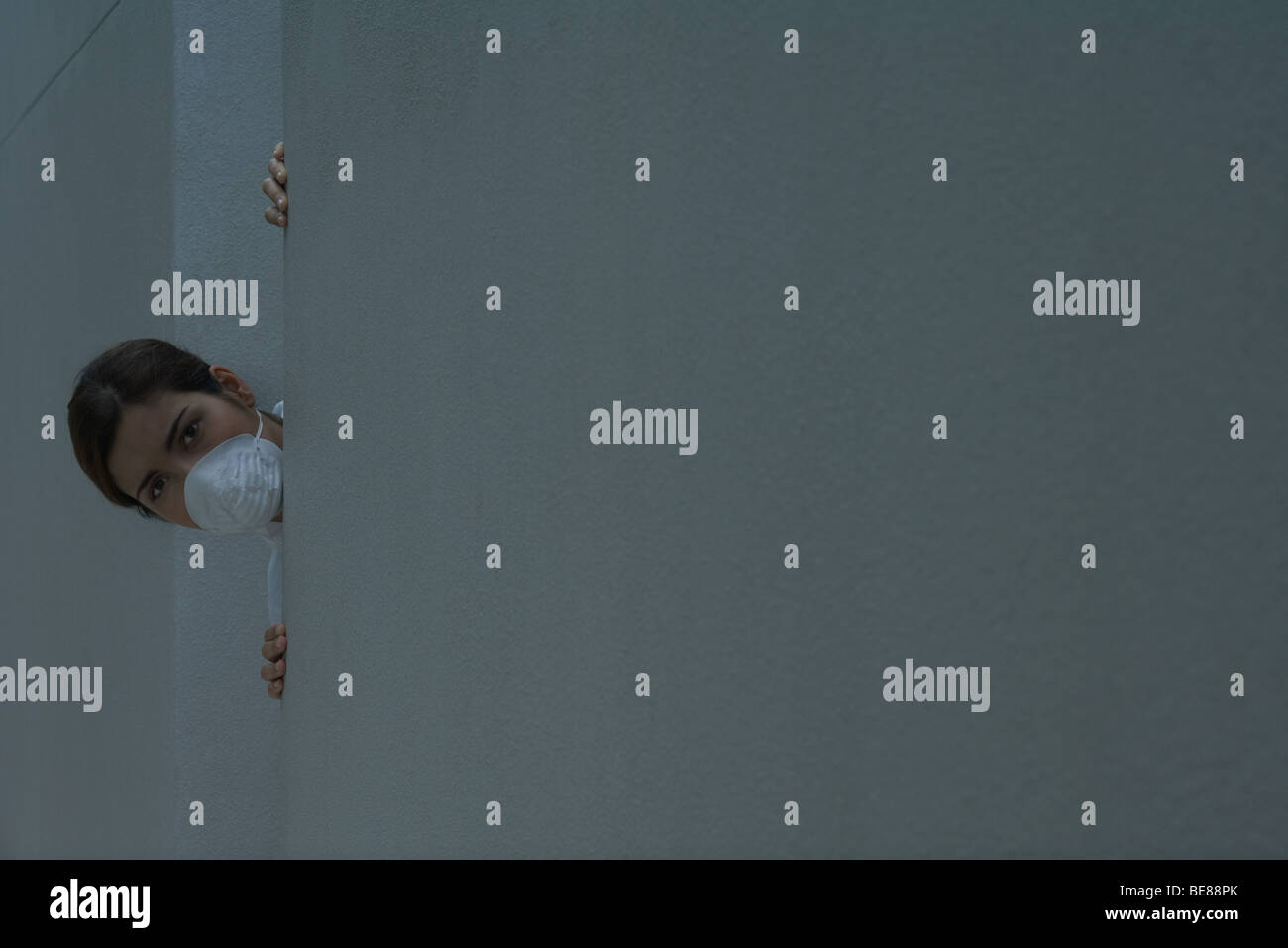 Woman peeking around corner hi-res stock photography and images - Alamy