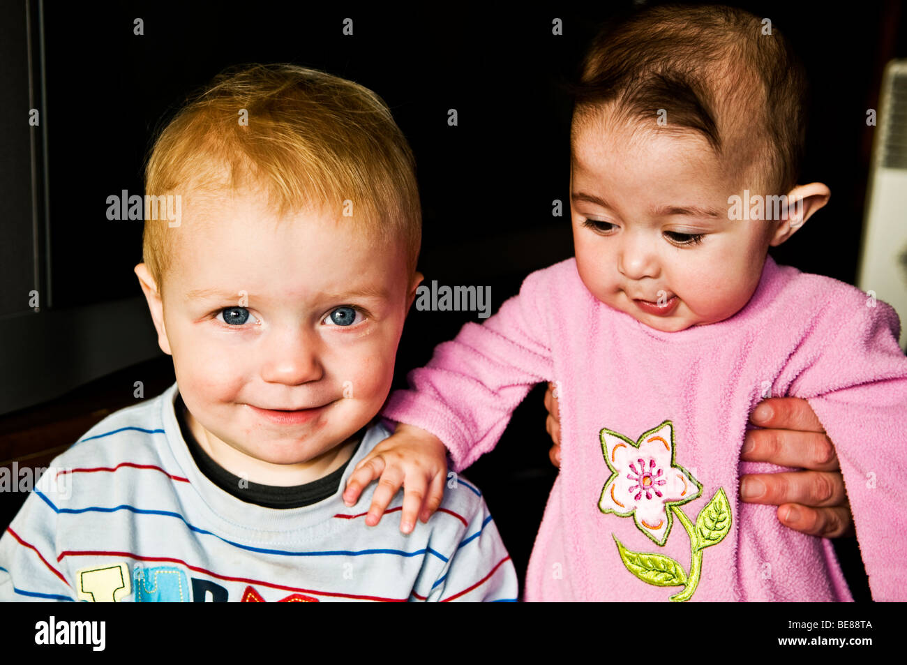 Two cute babies together Stock Photo - Alamy