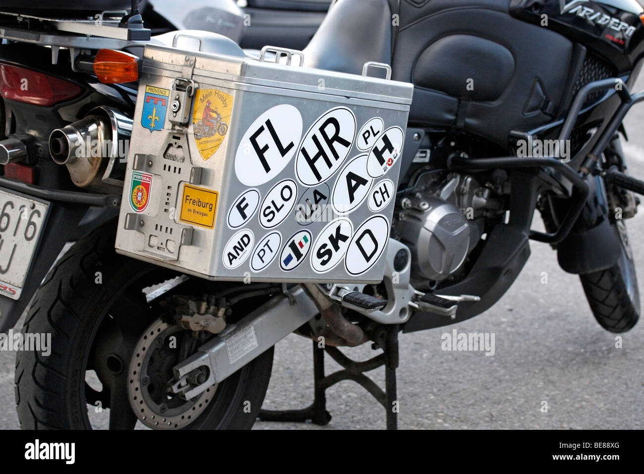Motorcycle covered with stickers Stock Photo - Alamy