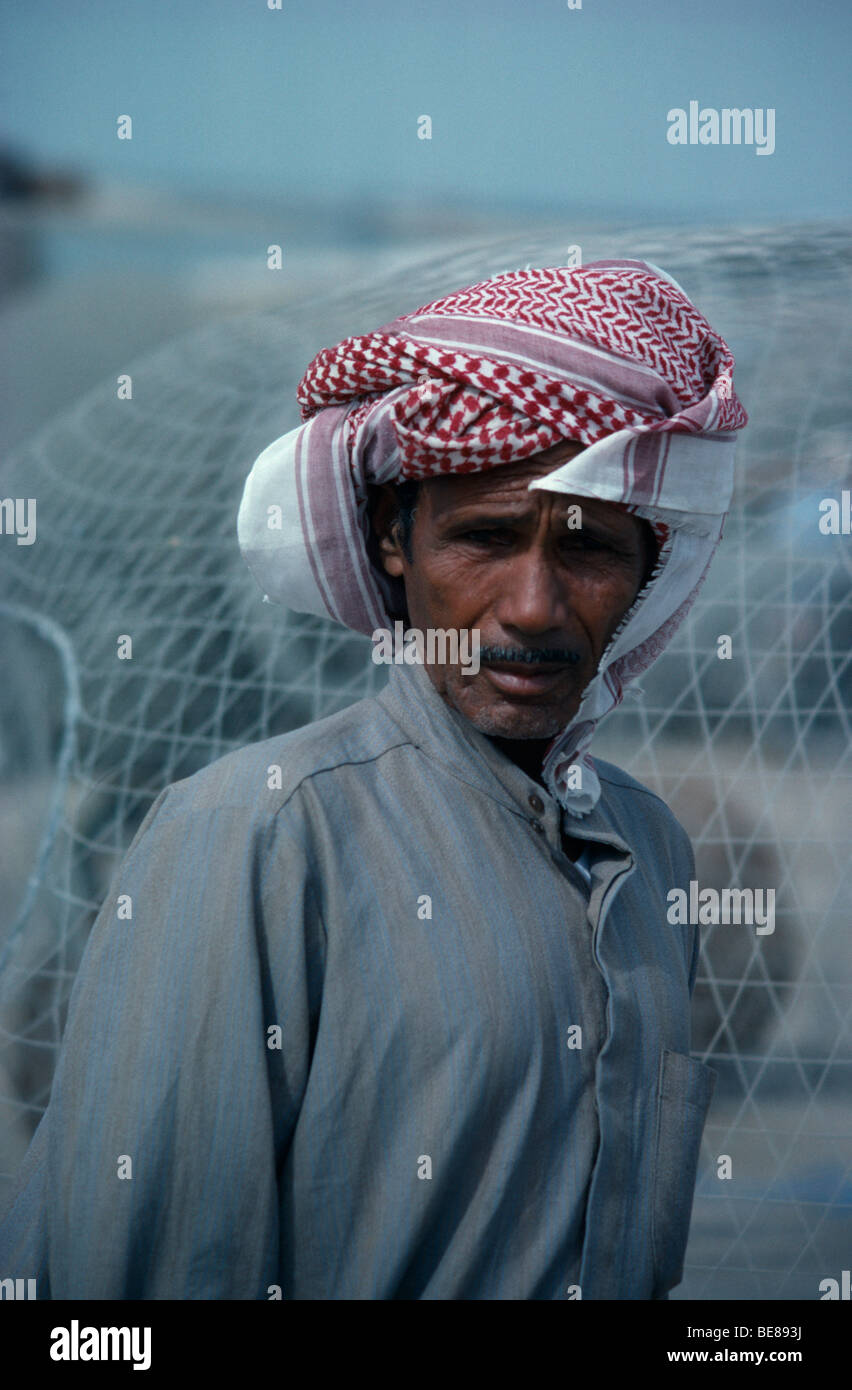 Kuwait Middle East Gulf State Portrait of man wearing traditional red ...