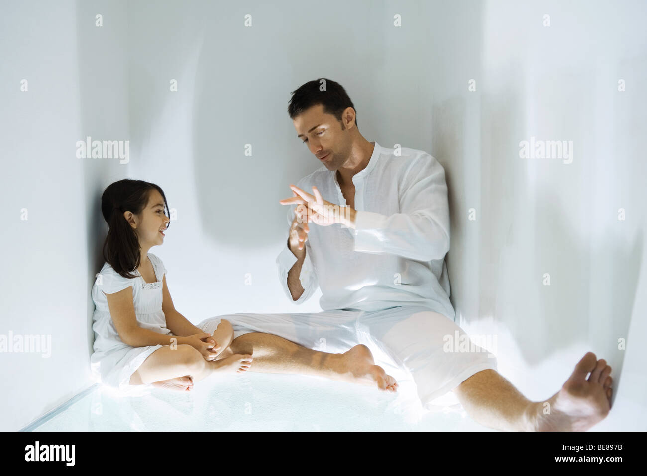Father performing magic trick for daughter Stock Photo - Alamy
