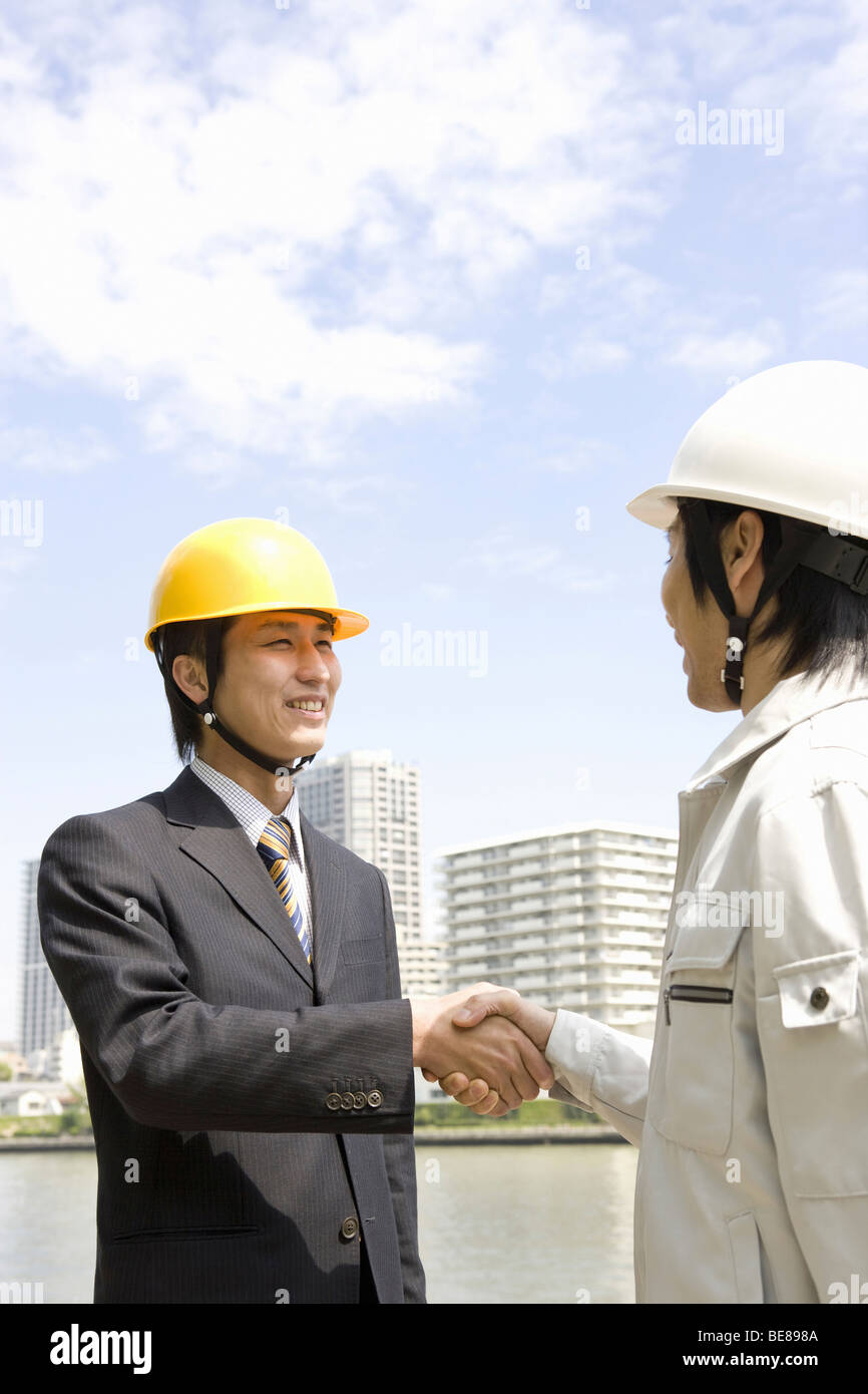 Workman and Businessman Stock Photo - Alamy